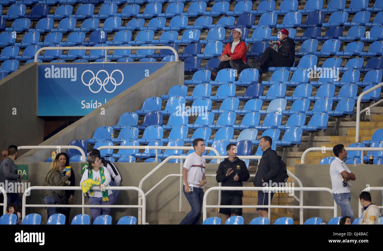 Rio de Janeiro, Brazil. 12th Aug, 2016. A few spectators sit in the ...