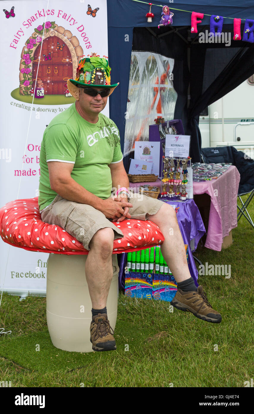 Burley, Hampshire, UK 13 August 2016. Man elf sitting on toadstool at ...