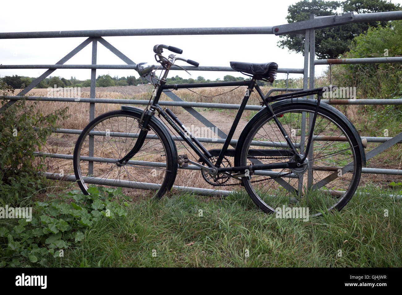 An old Phillips Roadster bicycle leaning against a farm gate ...
