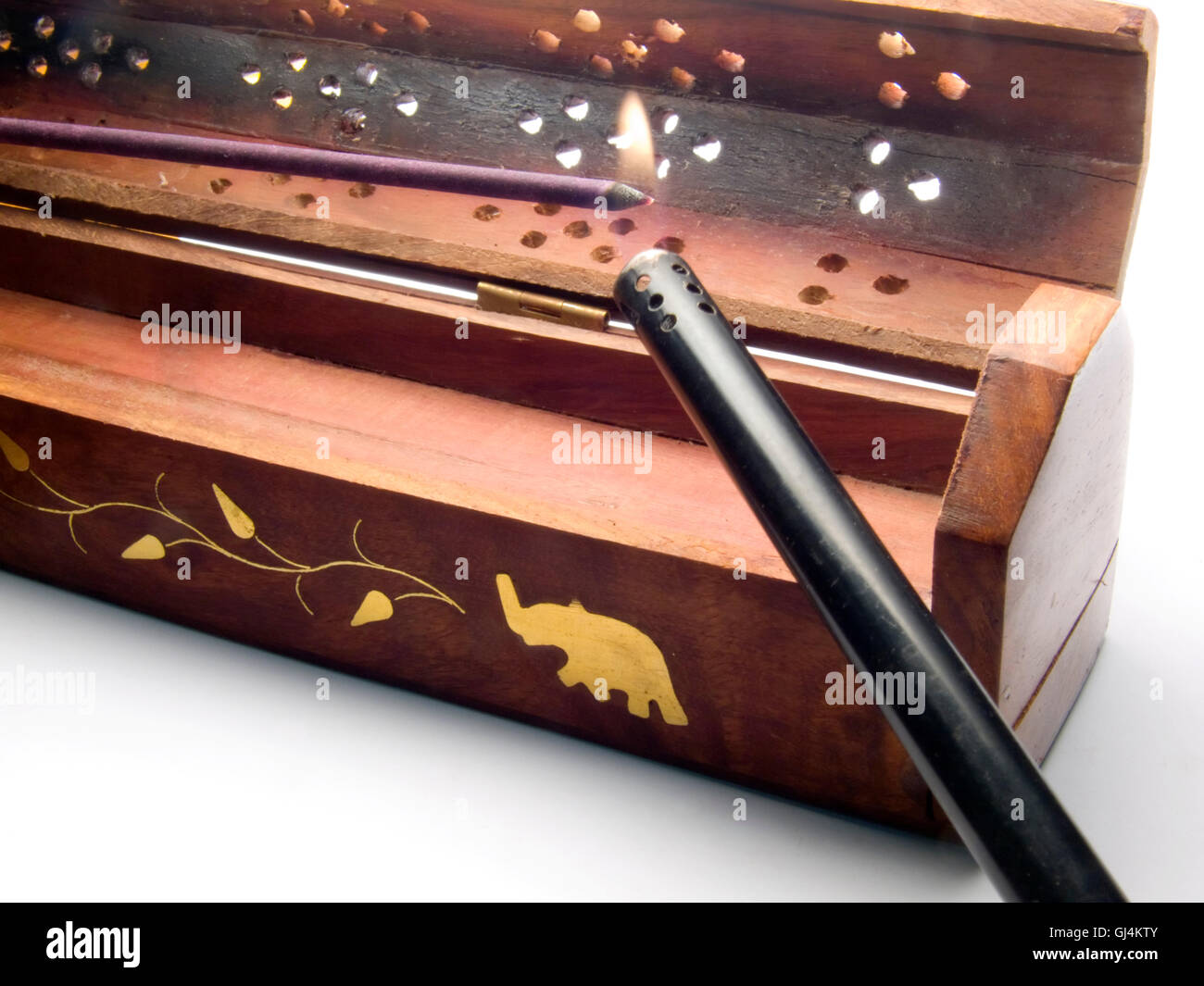 Closeup of an incense stick being lit with a lighter Stock Photo - Alamy