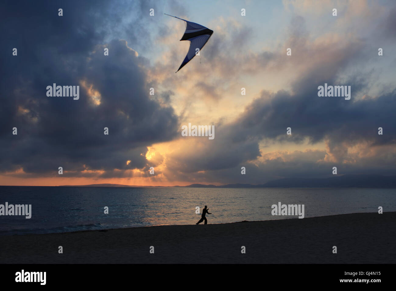 Flying a kite at sunset Stock Photo - Alamy