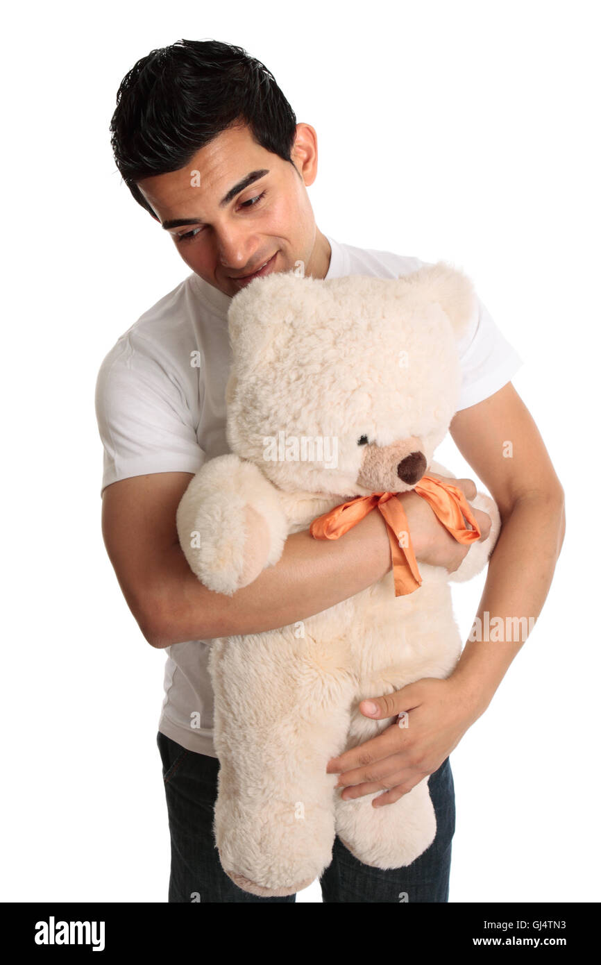 Man hugging a teddy Stock Photo - Alamy