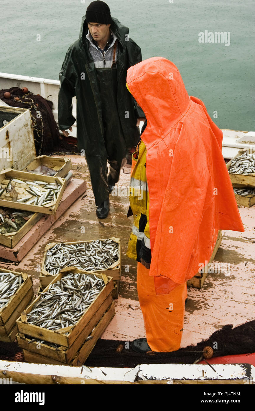 Fishermen on trawler boat Stock Photo - Alamy