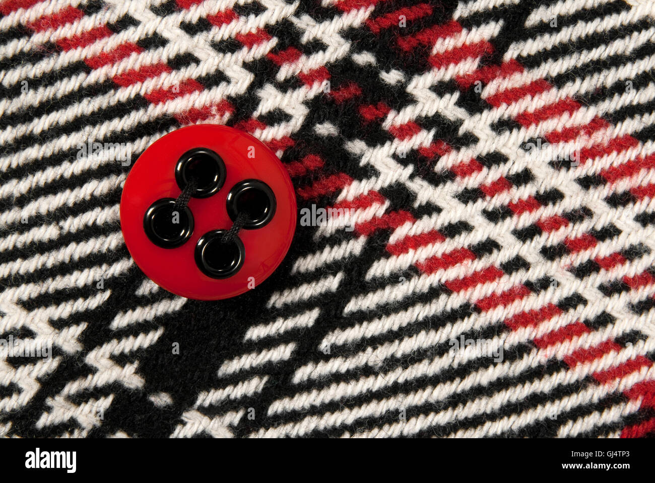 Red button on checked fabric Stock Photo - Alamy