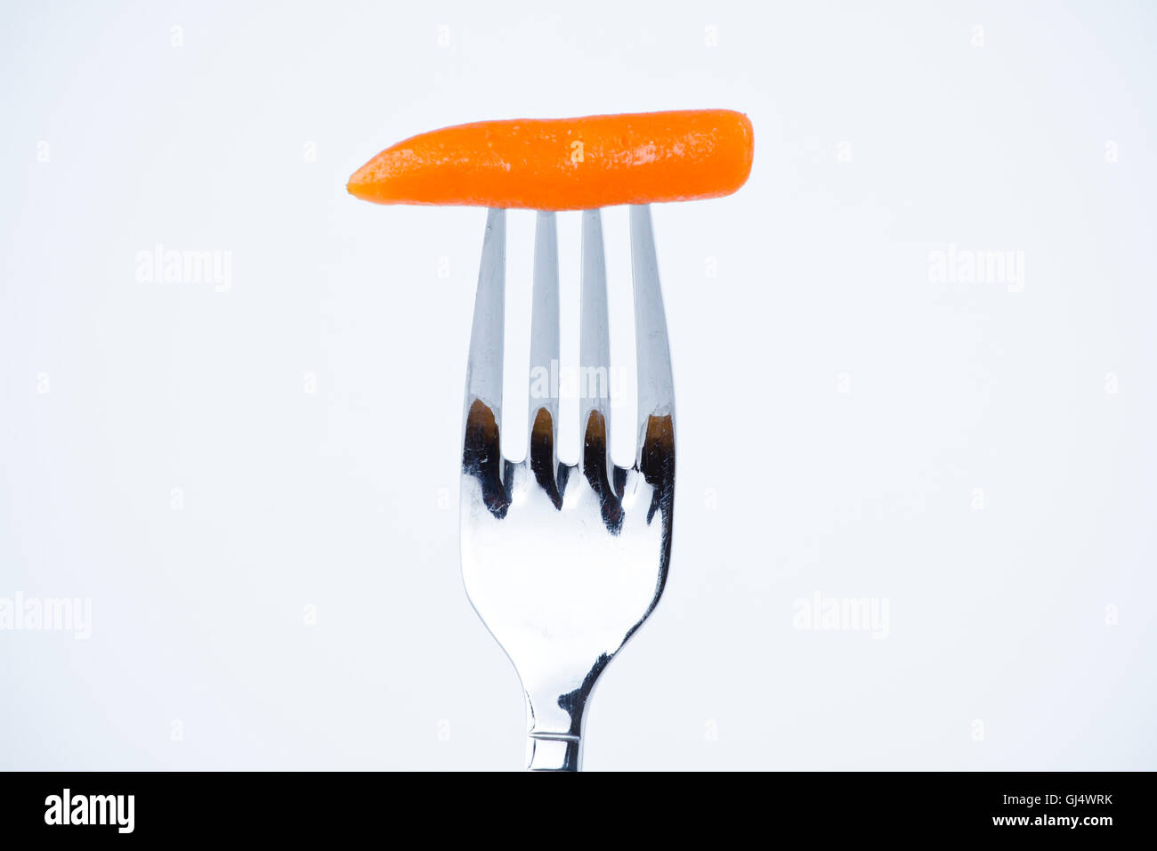 diet, carrot bite in a fork Stock Photo - Alamy