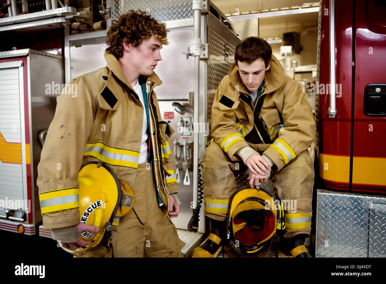 Two young Firemen Stock Photo - Alamy