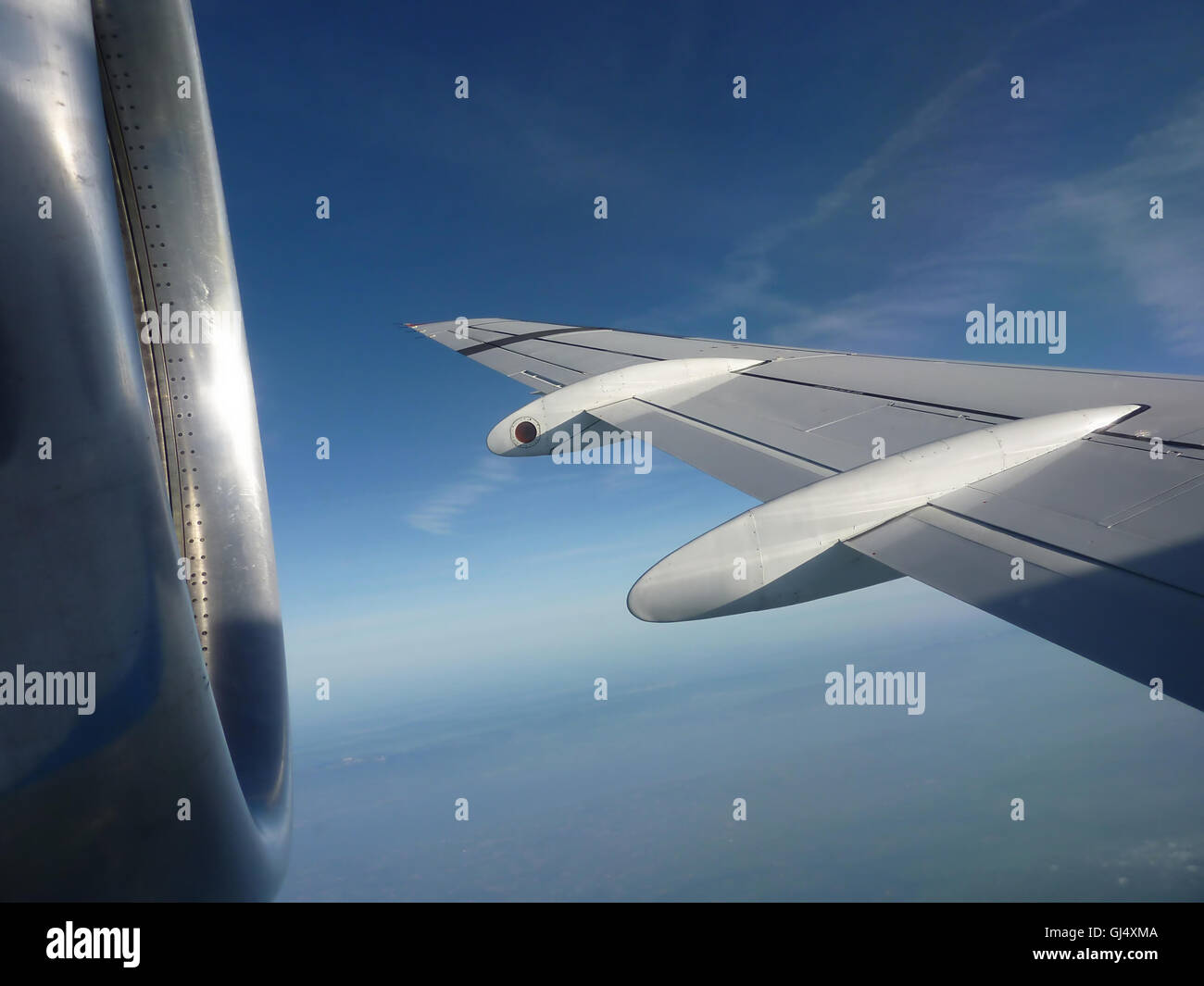 Flying plane wing and motor Stock Photo - Alamy