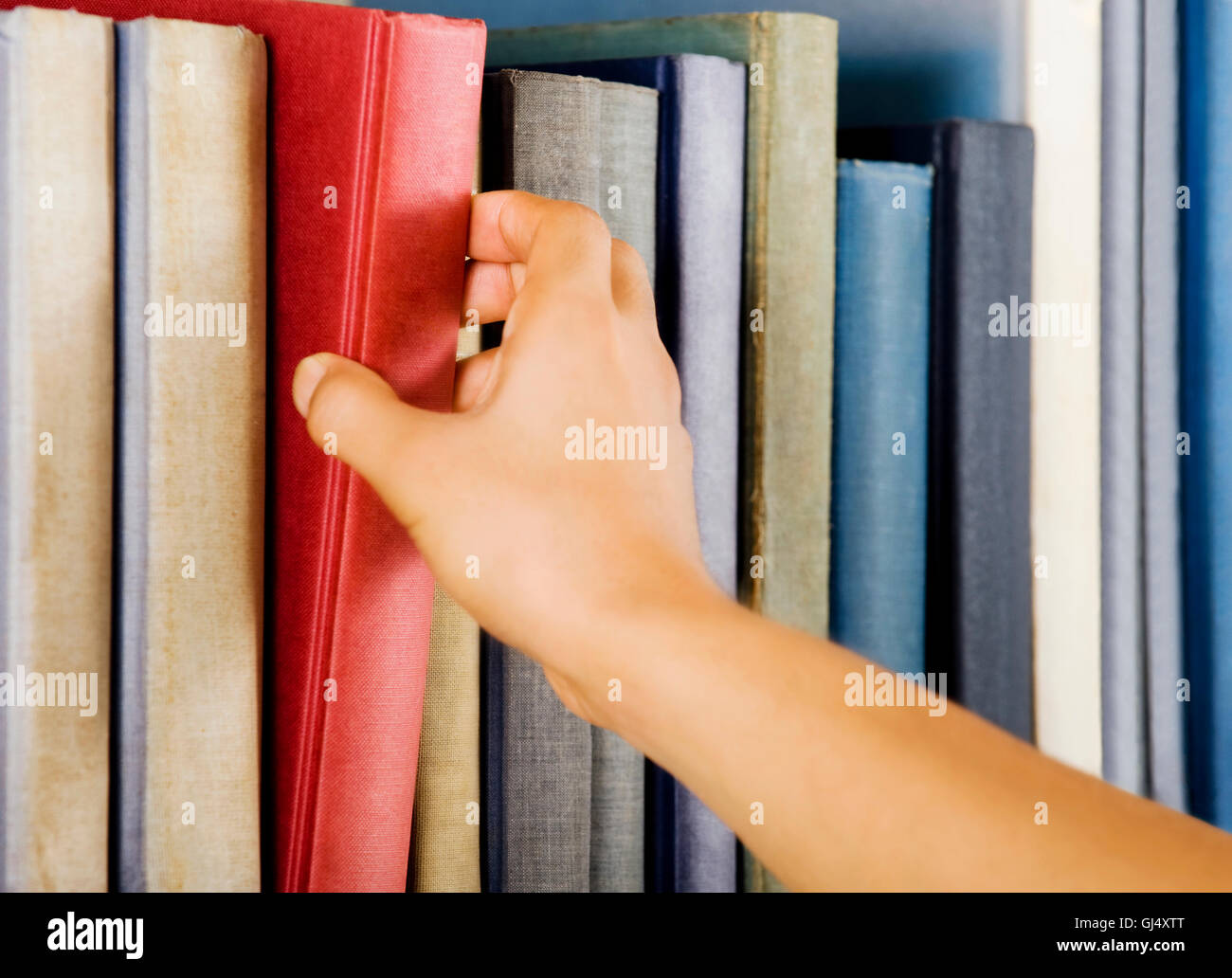 Selecting a book Stock Photo - Alamy