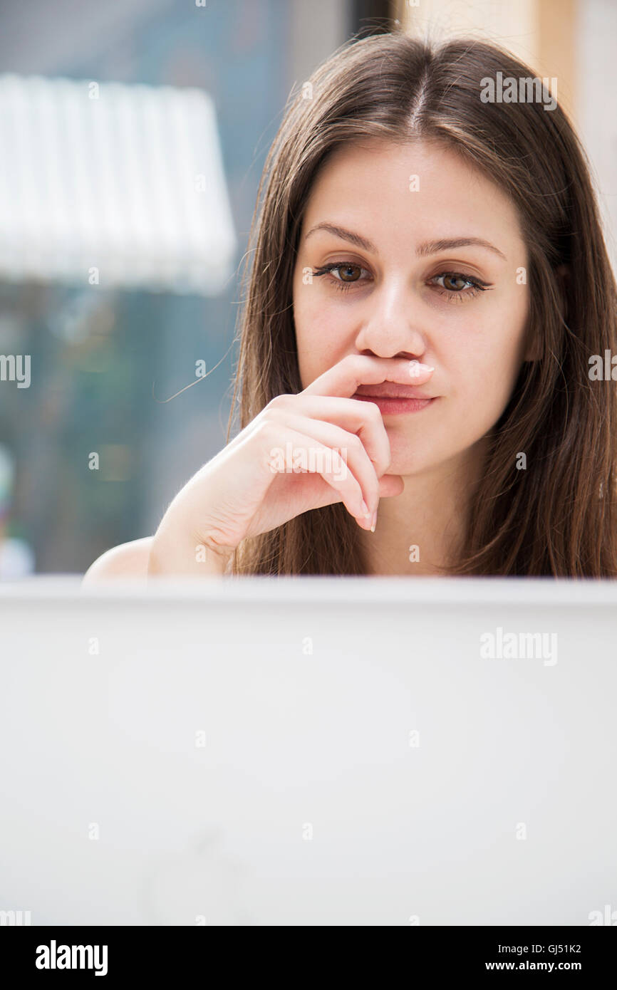 Pretty young woman working on laptop in the office Stock Photo - Alamy