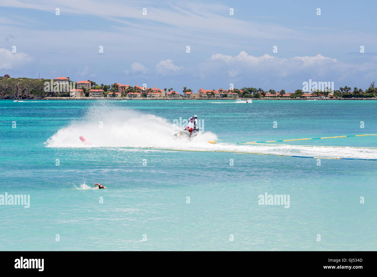 Jet Skier Swerving Very Near a Swimmer Stock Photo - Alamy