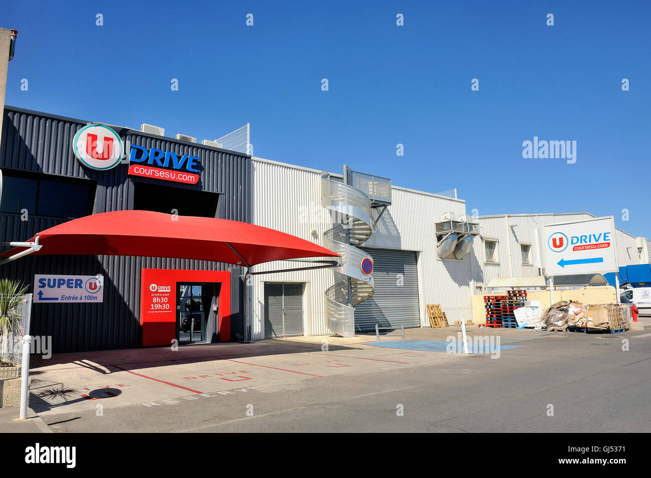 Drive to French supermarket delivery point to pick orders placed with ...