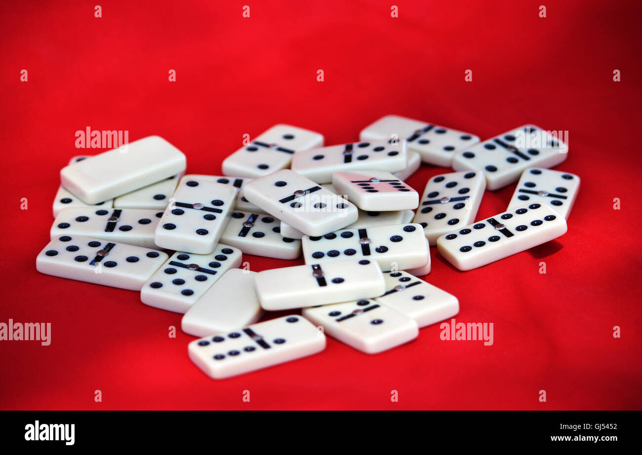 beautiful dominoes close up over red background. Short depth of field ...