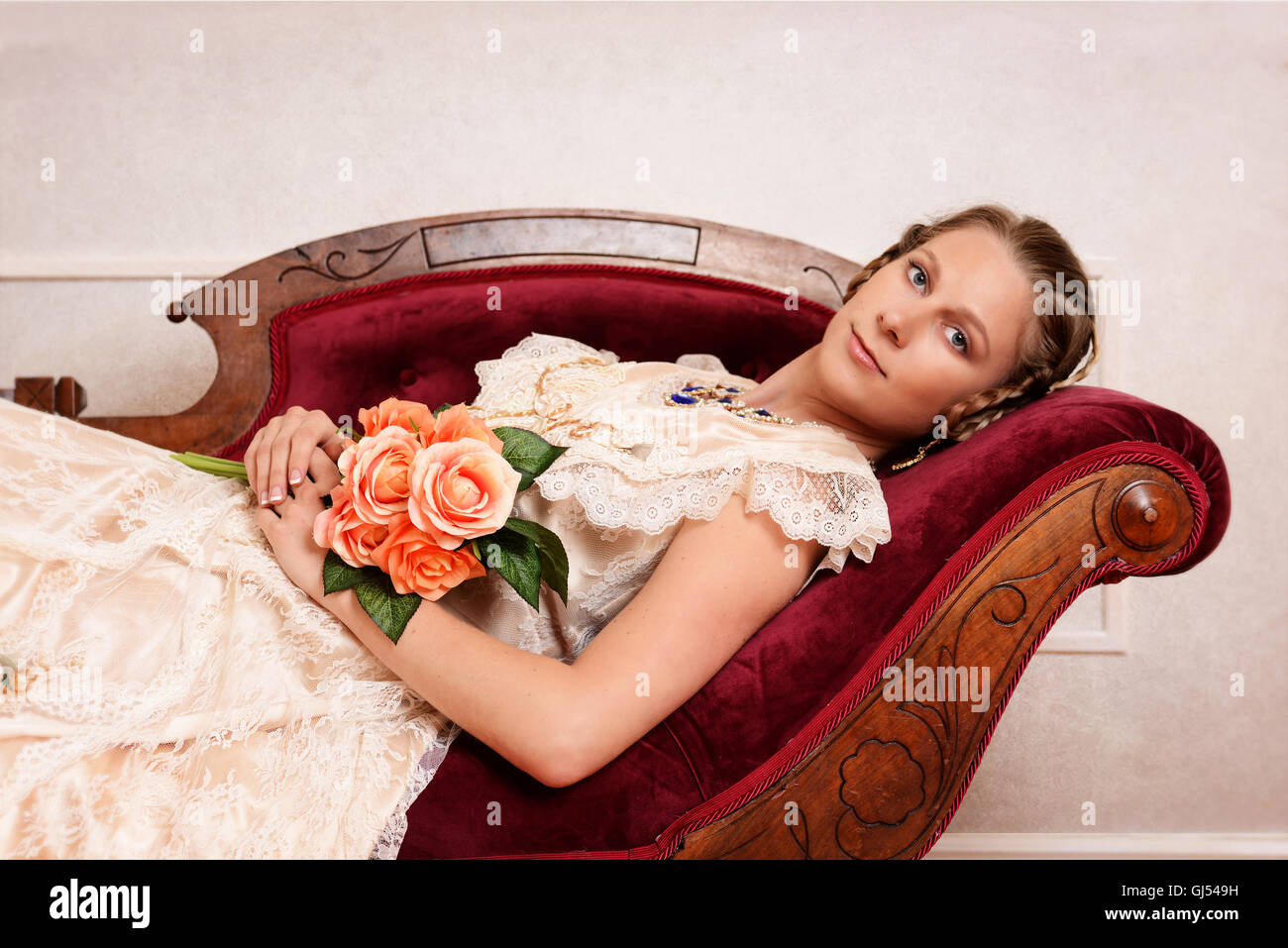 Victorian woman with flowers on fainting couch Stock Photo - Alamy