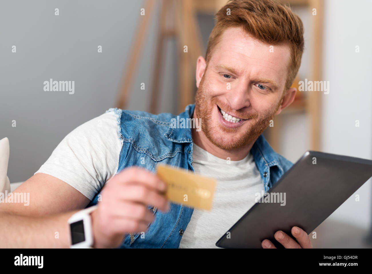 Joyful handsome man holding credit card Stock Photo - Alamy