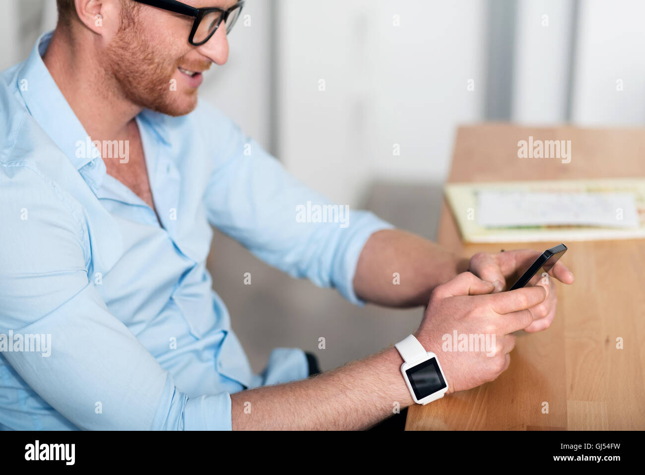 Positive man using cell phone Stock Photo - Alamy