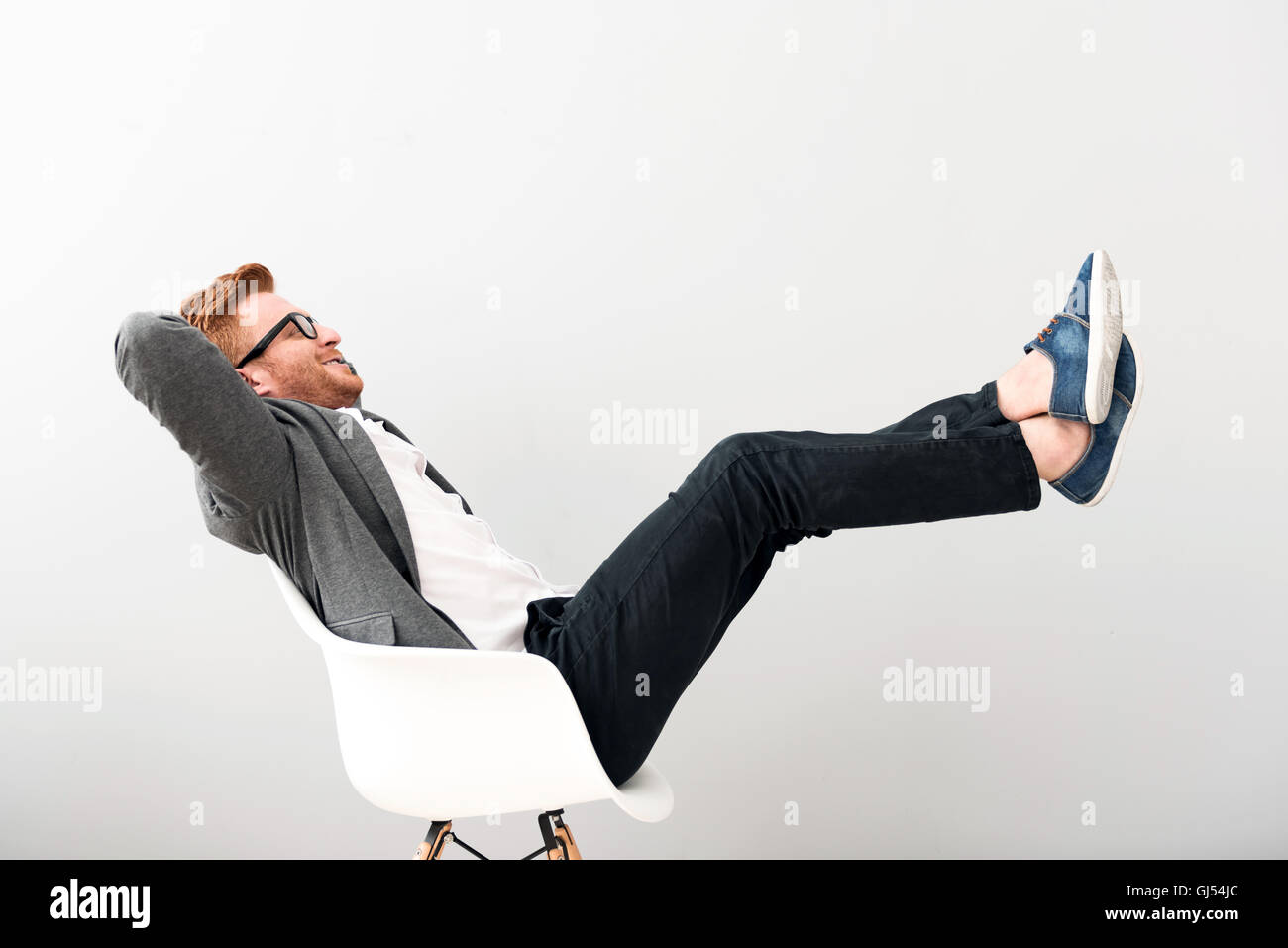 Joyful man resting in the chair Stock Photo - Alamy