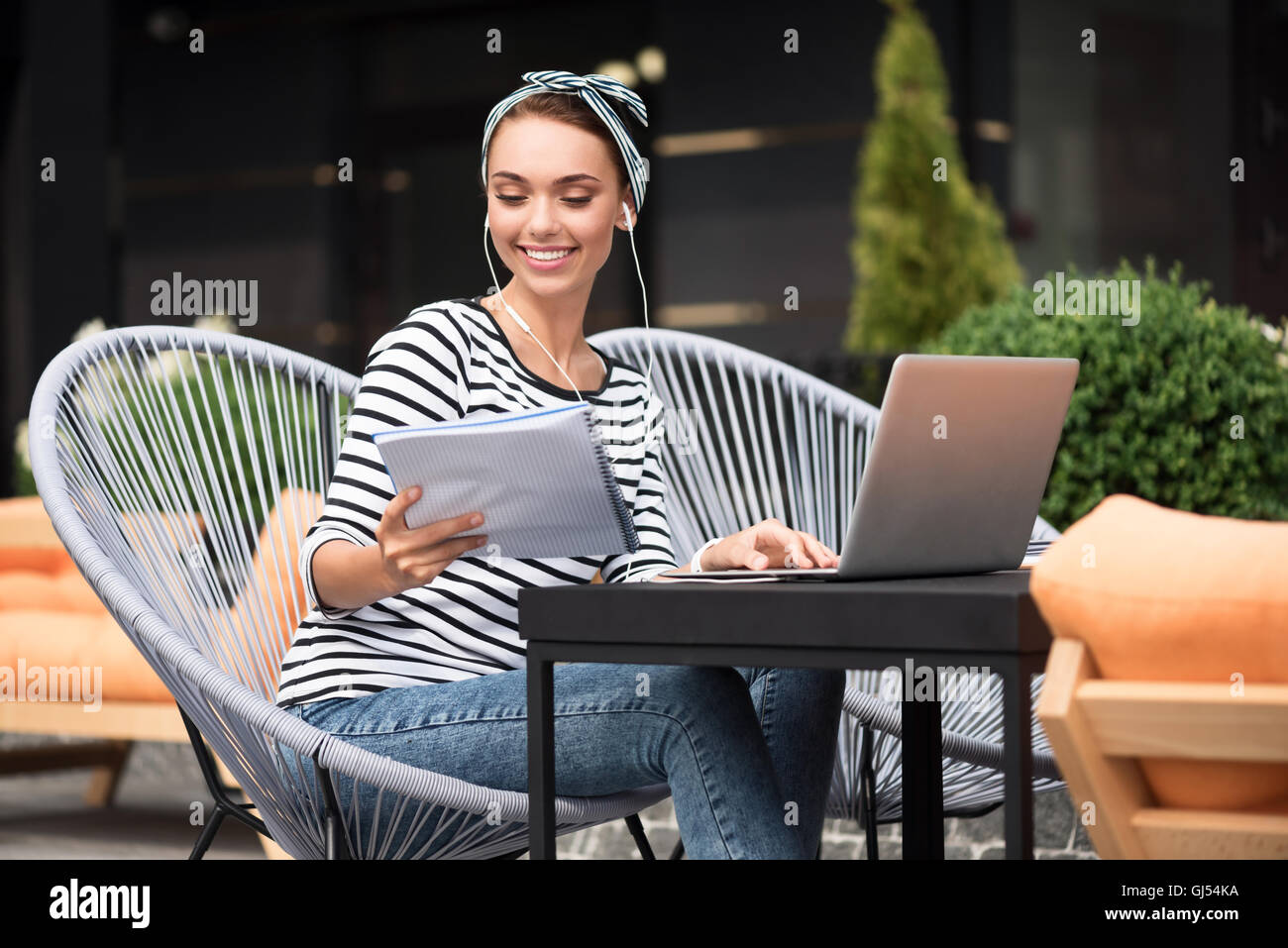 Positive woman using laptop Stock Photo - Alamy