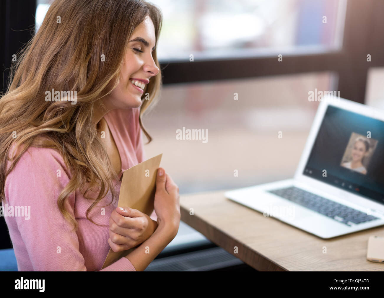 Positive woman holding letter Stock Photo - Alamy