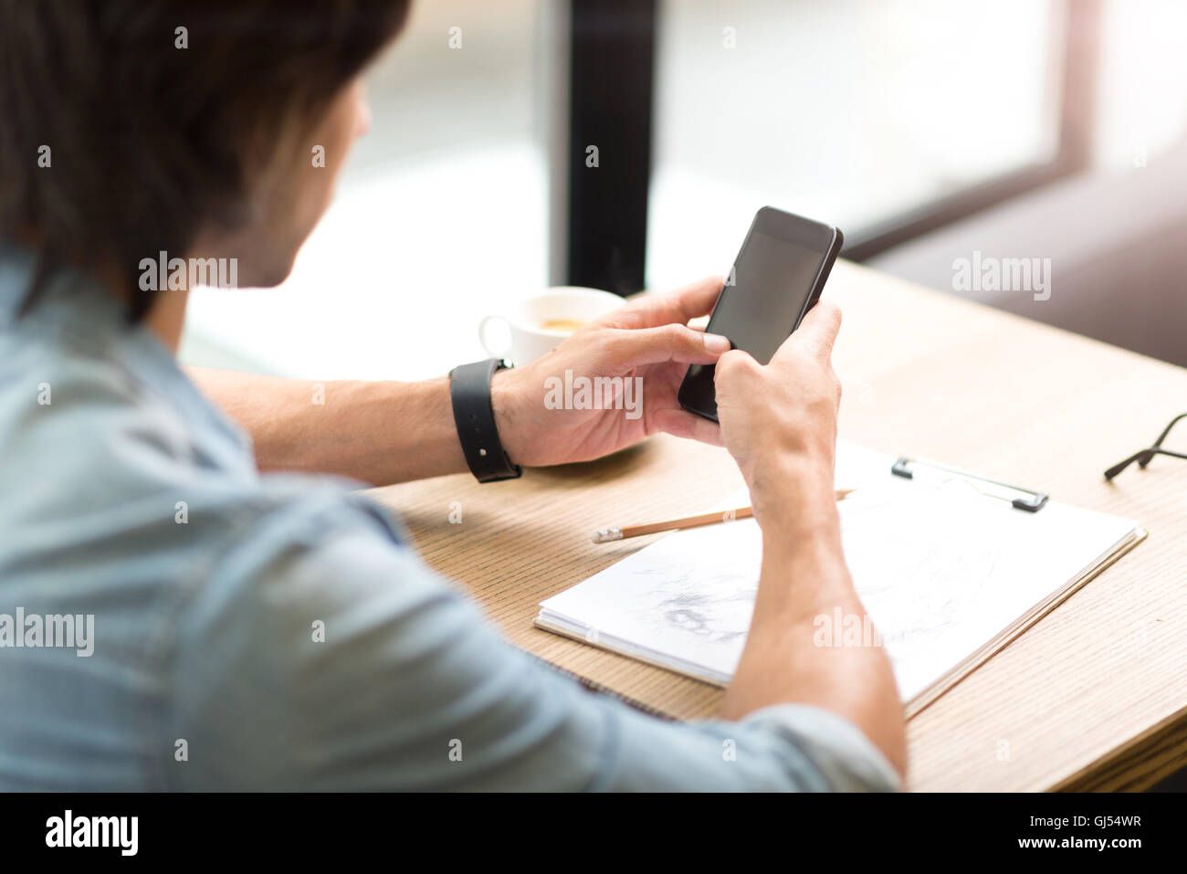 Pleasant man using cell phone Stock Photo - Alamy