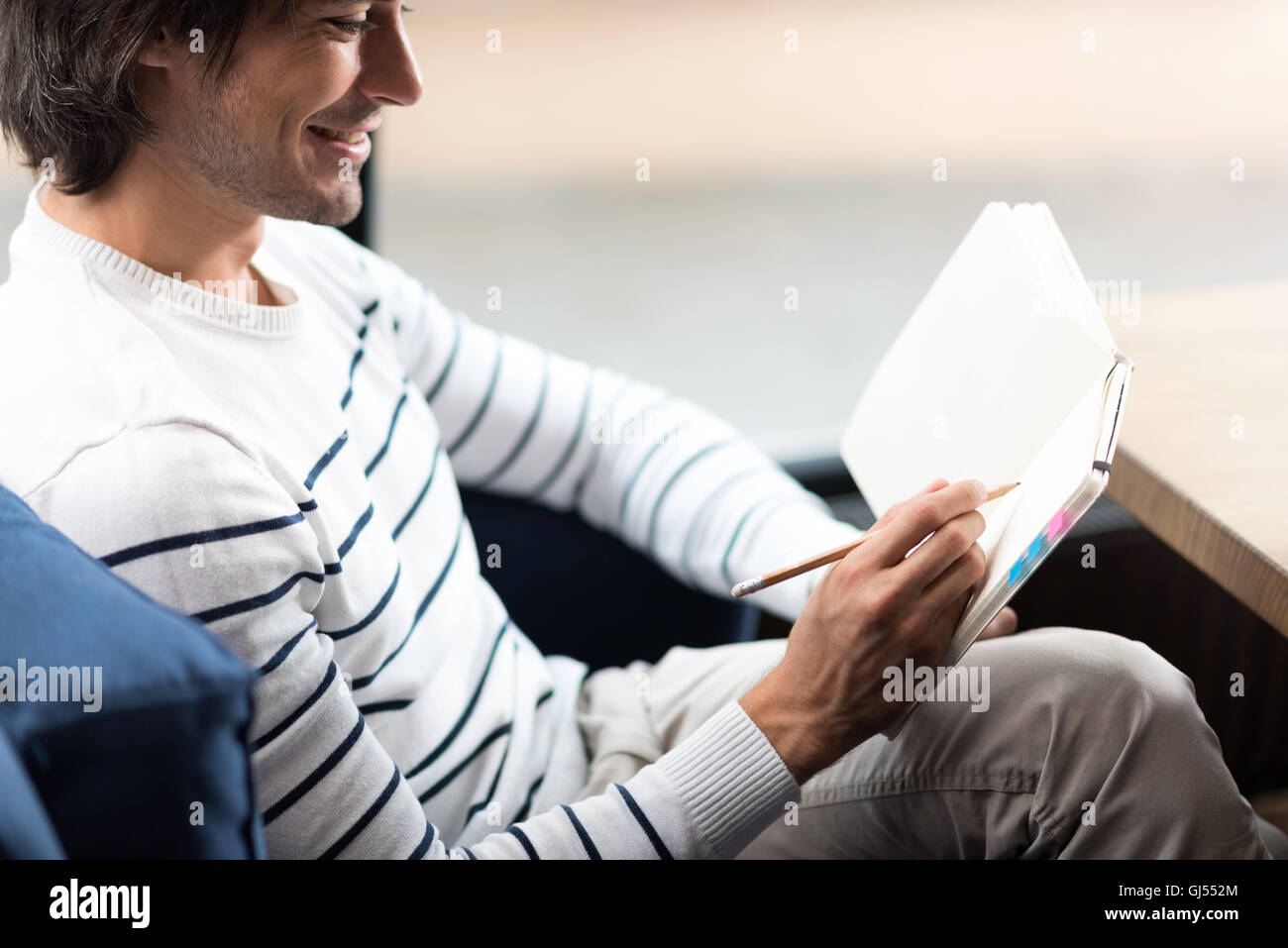 Positive man making notes Stock Photo - Alamy