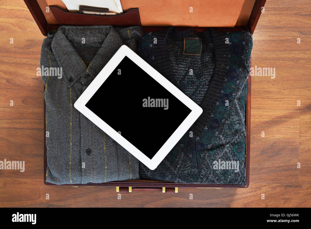Vintage travel background. Top view of old suitcase with clothes on ...