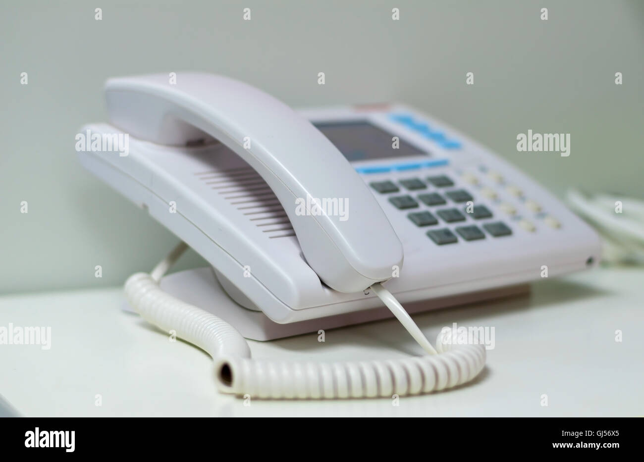 White telephone on white table Stock Photo - Alamy