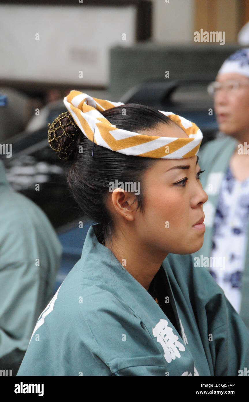 Young Japanese woman seen from profile wearing happy coat and turban on ...