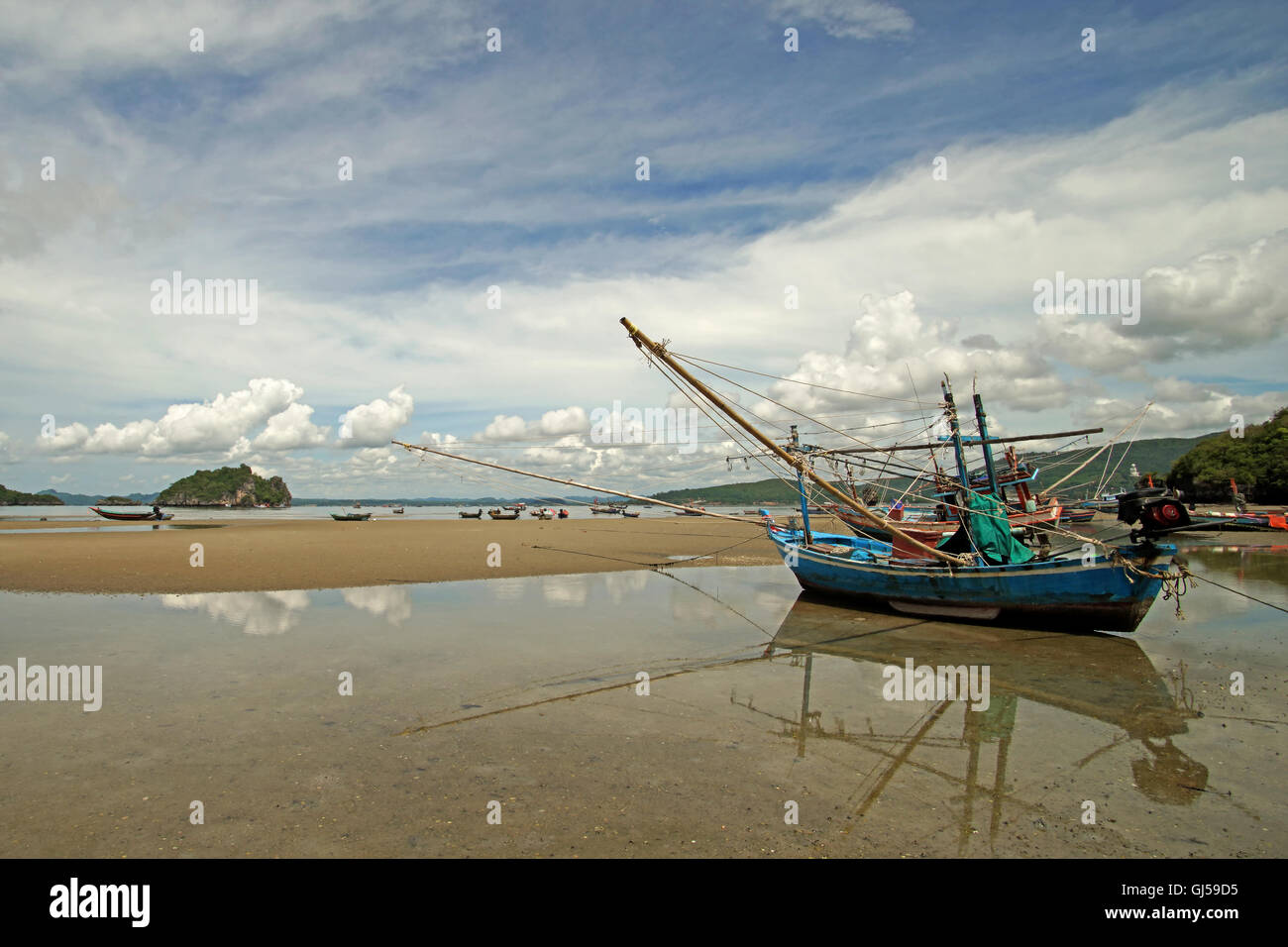 fishing boat on the beach with beautiful sky background Stock Photo - Alamy