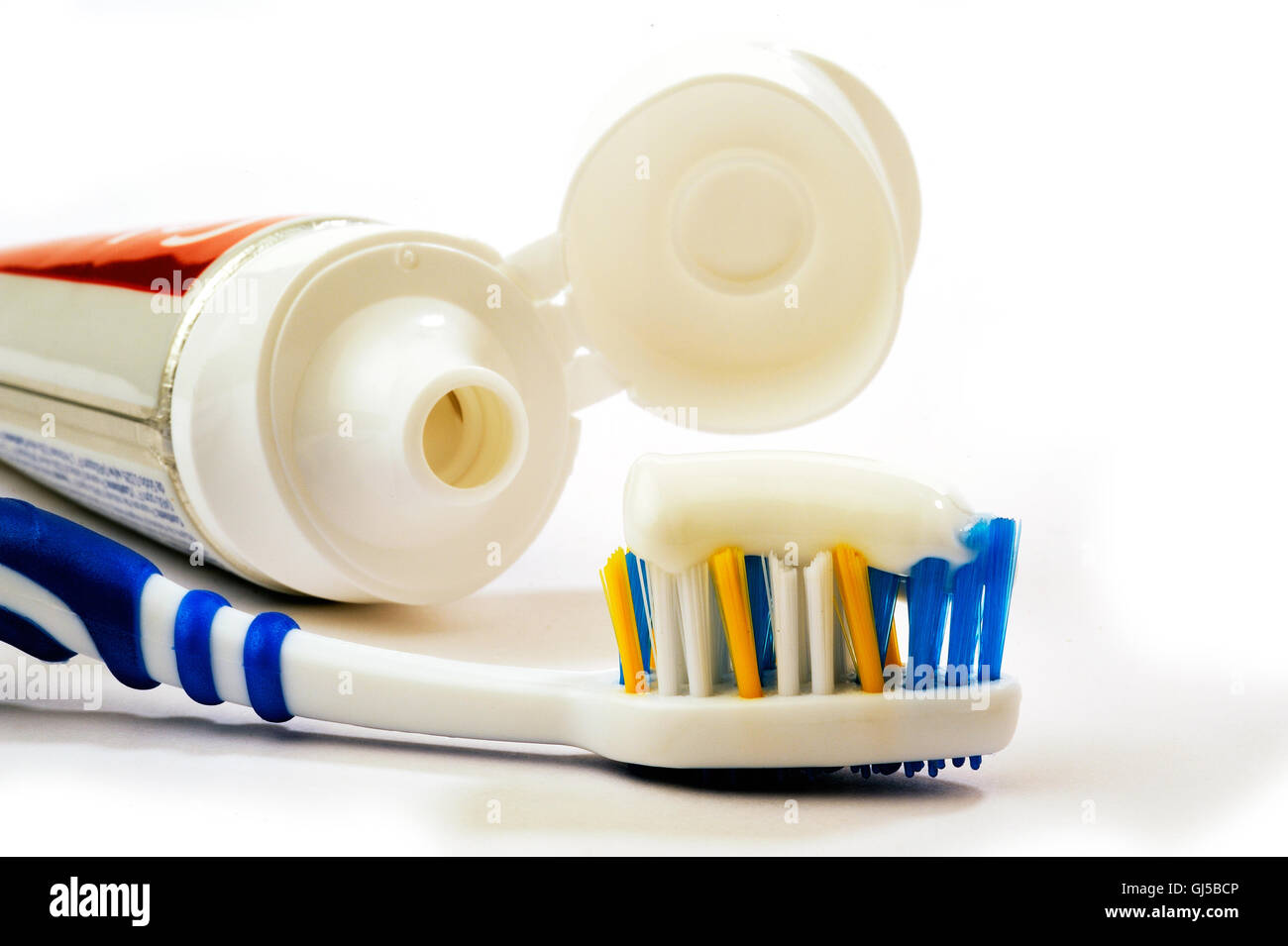 Entire tube of toothpaste with a toothbrush close-up on white ...