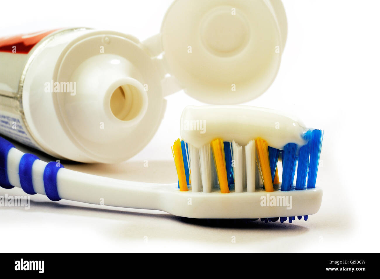 Entire tube of toothpaste with a toothbrush close-up on white ...