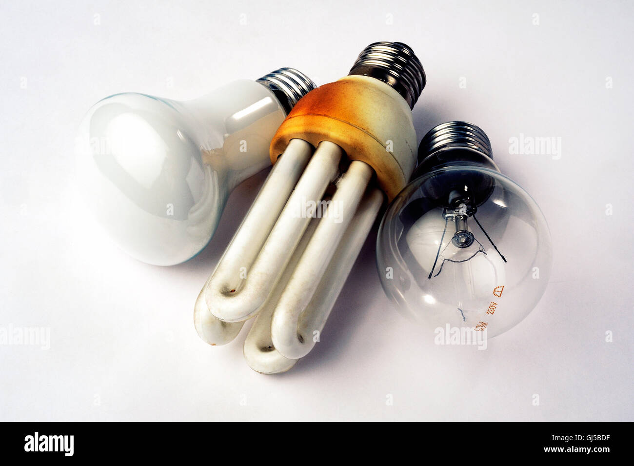 Recycling of used light bulb and economic legacy on white background ...