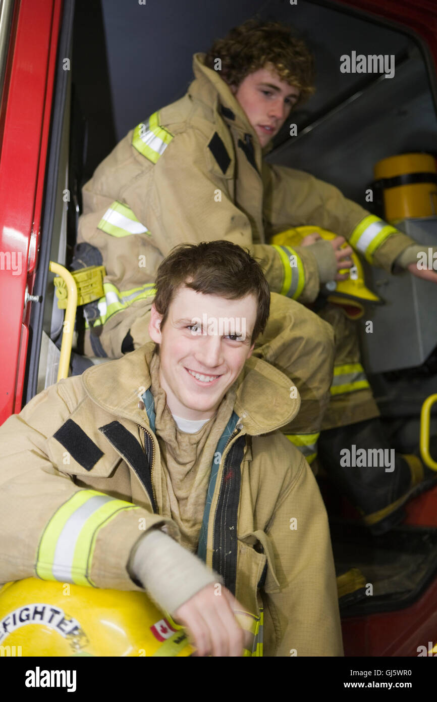 Two young Firemen Stock Photo - Alamy