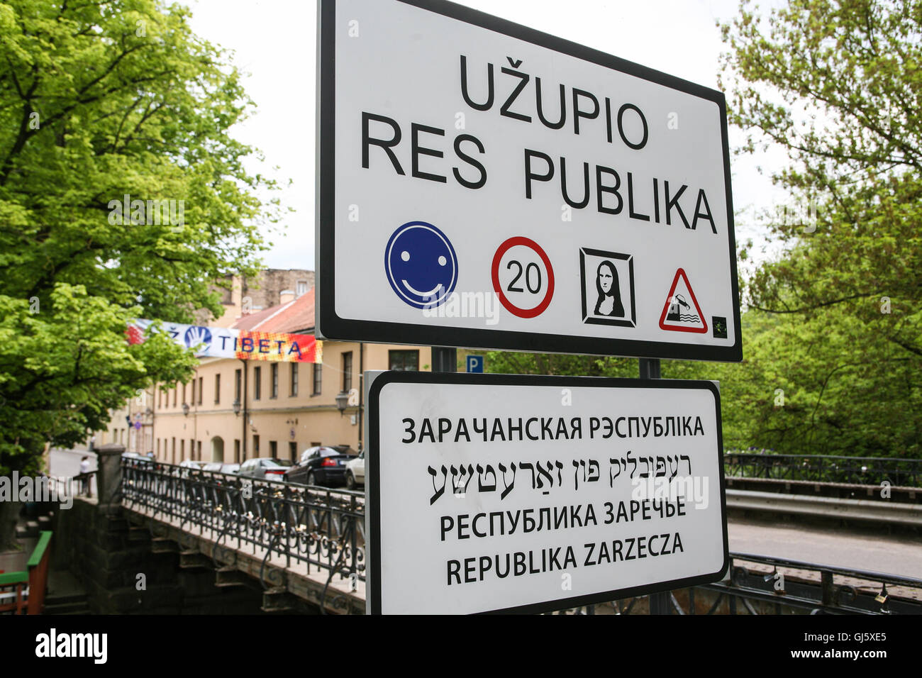 Sign announcing the republic status of Uzupio with bridge over River ...