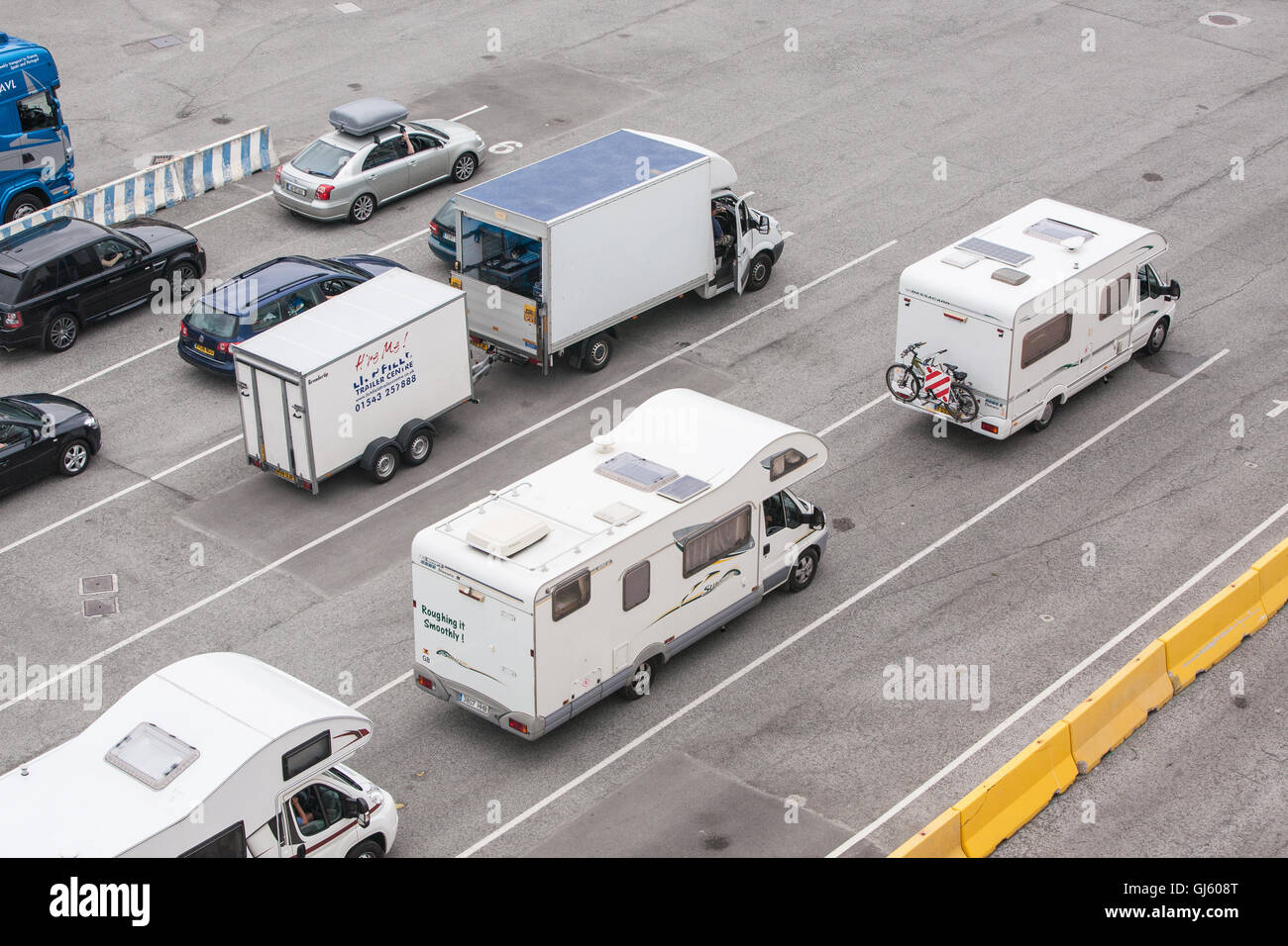 Motorhomes,cars,caravans,vehicles in a queue lined up at ferry port in ...