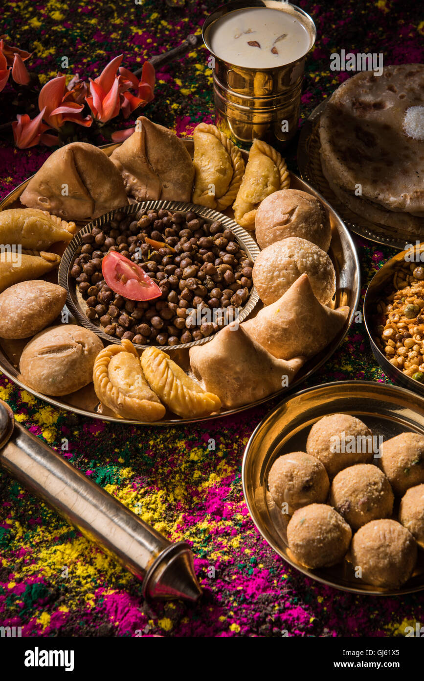 holi festival food with colours, indian festival holi, samosa, kachori ...