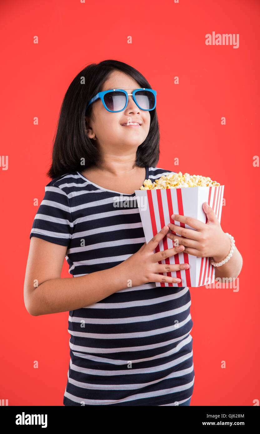happy girl eating popcorn, indian girl eating popcorn, asian girl and ...