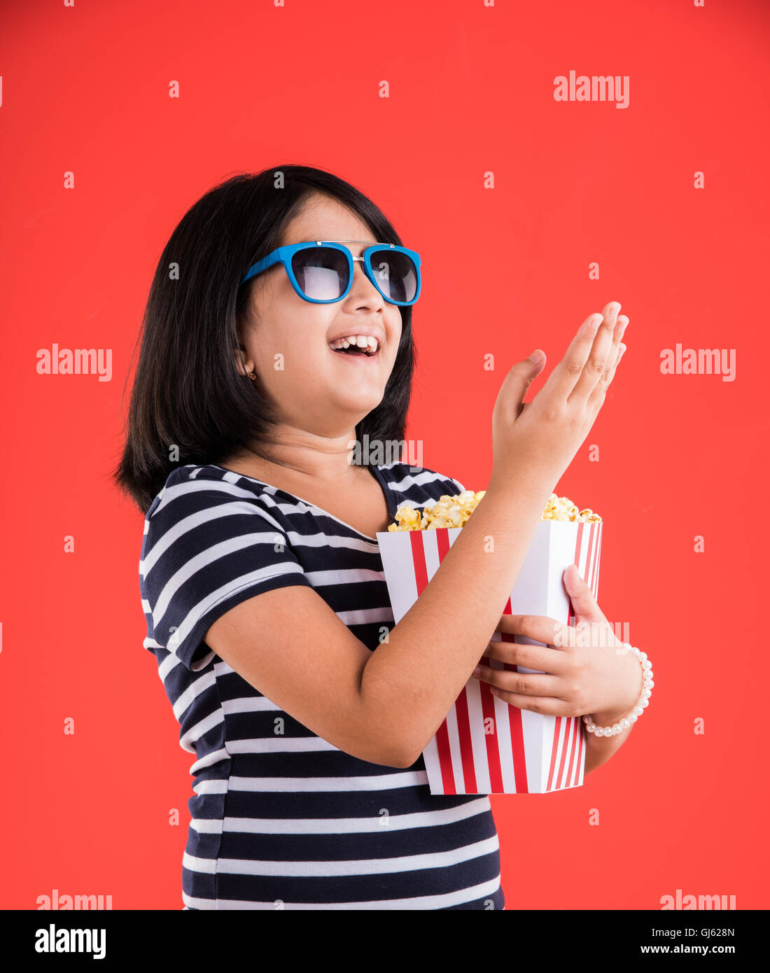 happy girl eating popcorn, indian girl eating popcorn, asian girl and ...