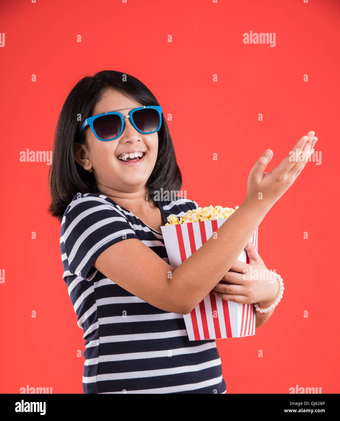 happy girl eating popcorn, indian girl eating popcorn, asian girl and ...
