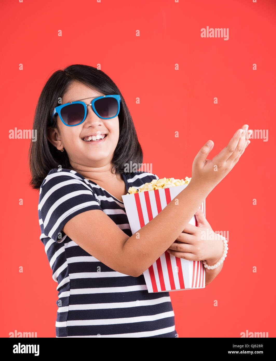 happy girl eating popcorn, indian girl eating popcorn, asian girl and ...