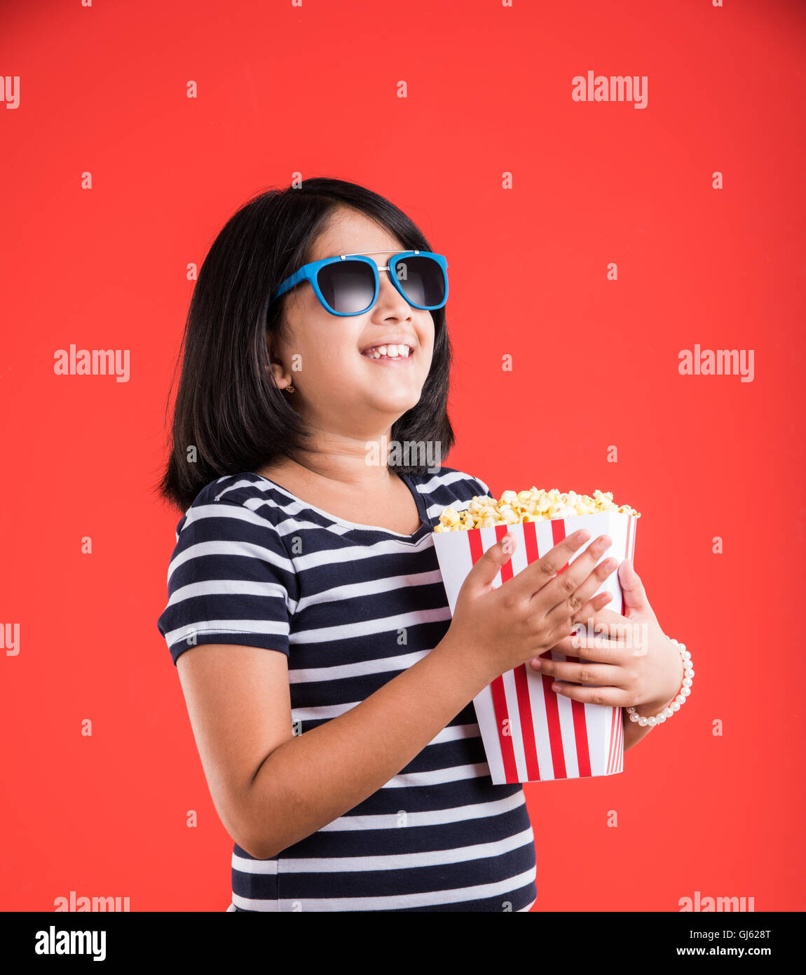 happy girl eating popcorn, indian girl eating popcorn, asian girl and ...