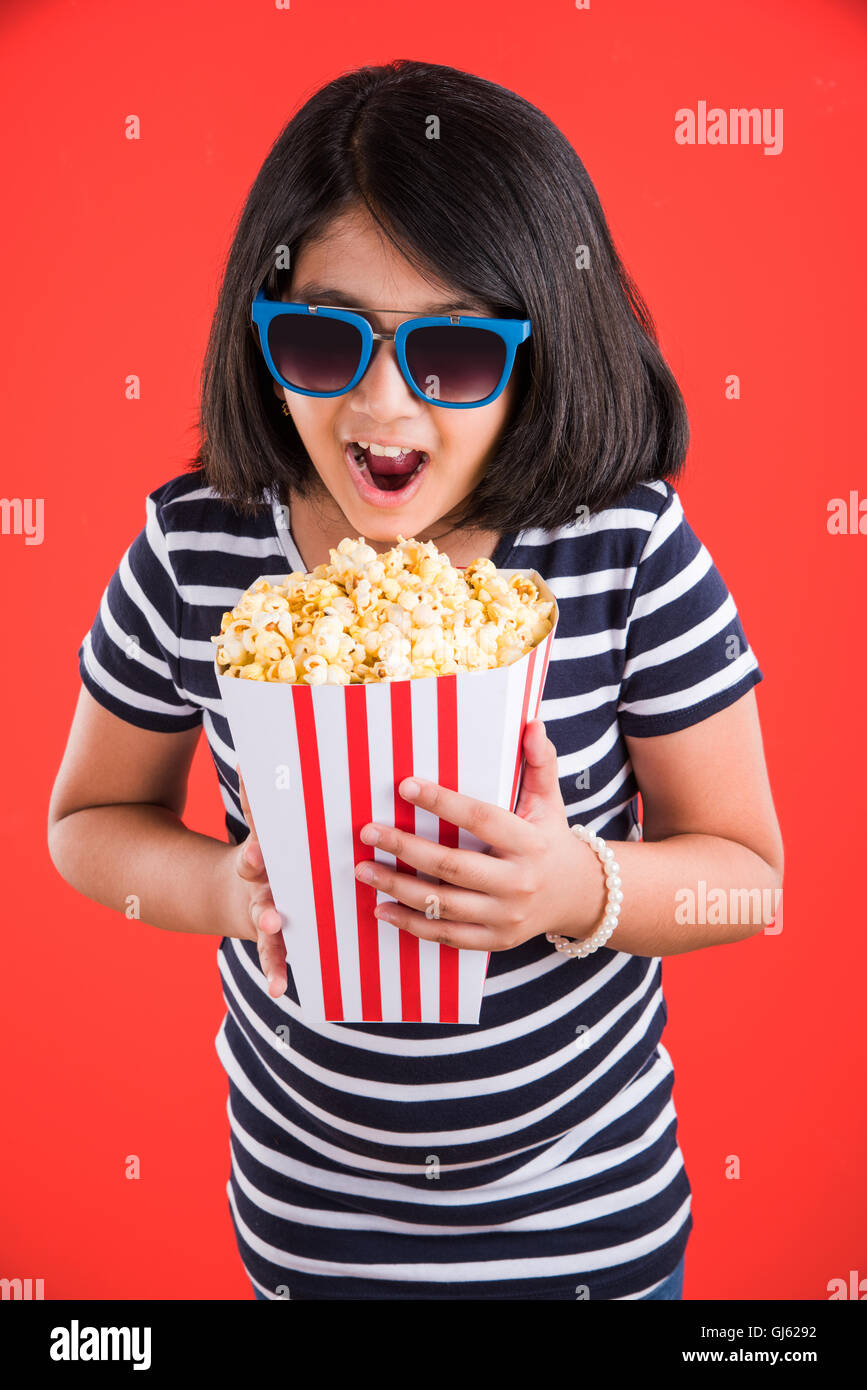 happy girl eating popcorn, indian girl eating popcorn, asian girl and ...