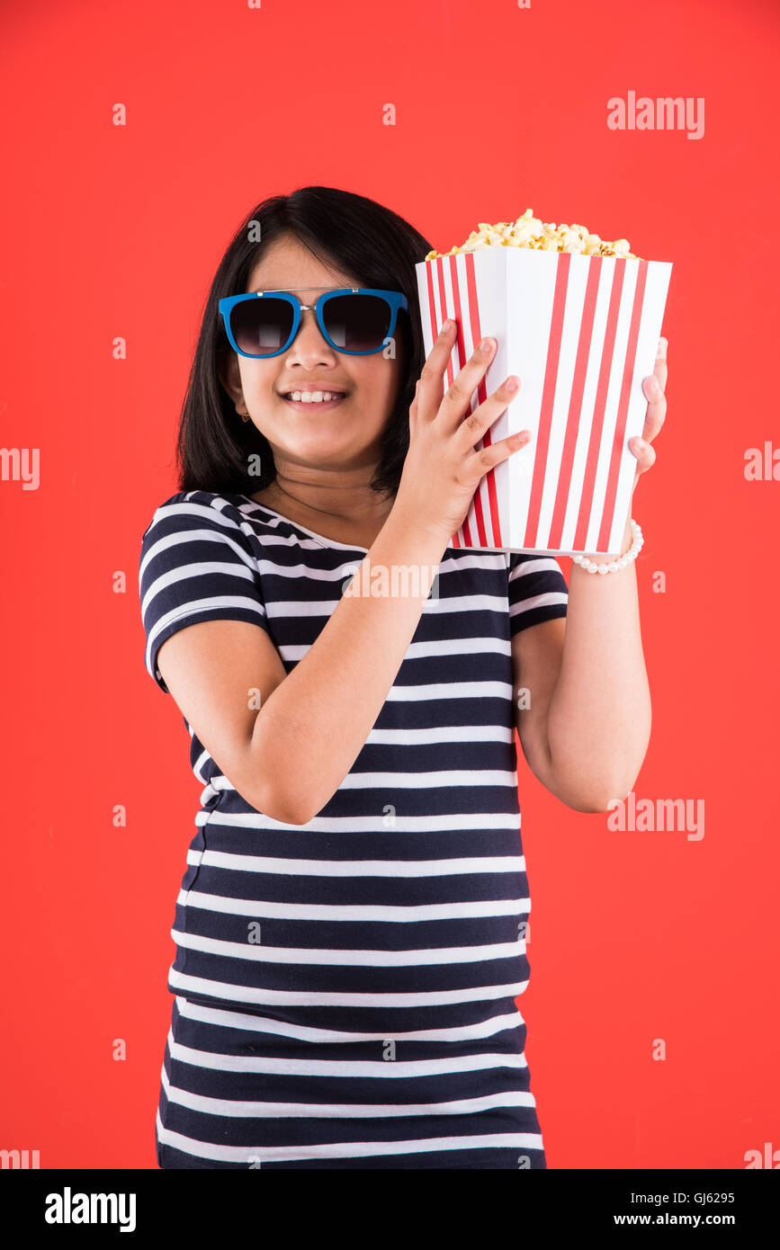 happy girl eating popcorn, indian girl eating popcorn, asian girl and ...