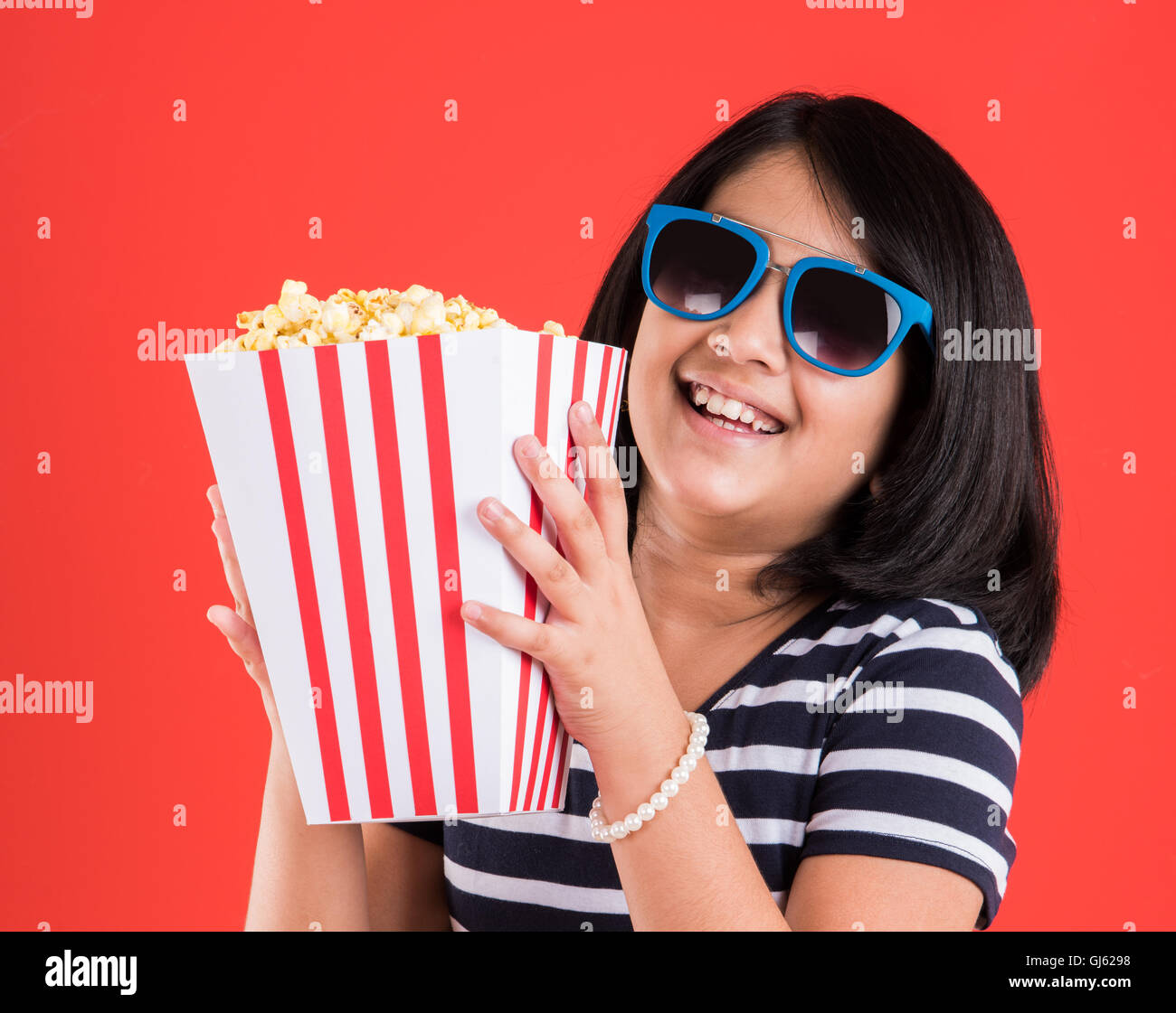 happy girl eating popcorn, indian girl eating popcorn, asian girl and ...