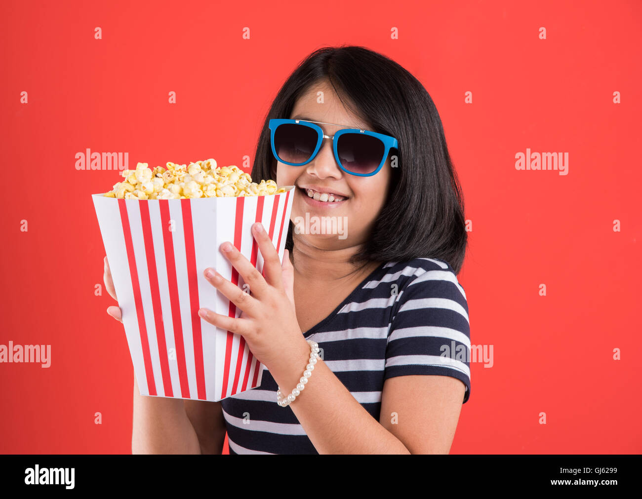 happy girl eating popcorn, indian girl eating popcorn, asian girl and ...