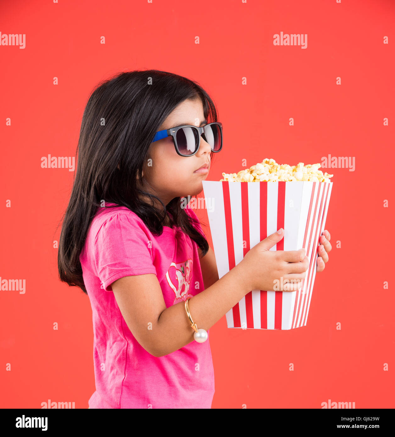 happy girl eating popcorn, indian girl eating popcorn, asian girl and ...