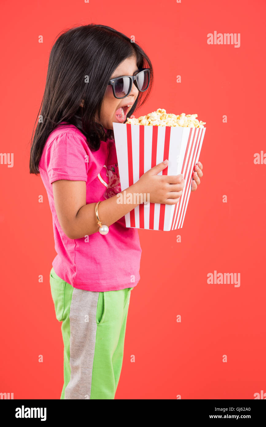 happy girl eating popcorn, indian girl eating popcorn, asian girl and ...