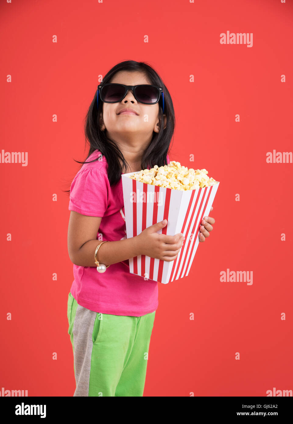 happy girl eating popcorn, indian girl eating popcorn, asian girl and ...