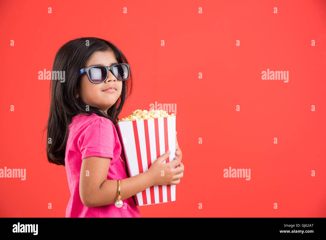 happy girl eating popcorn, indian girl eating popcorn, asian girl and ...