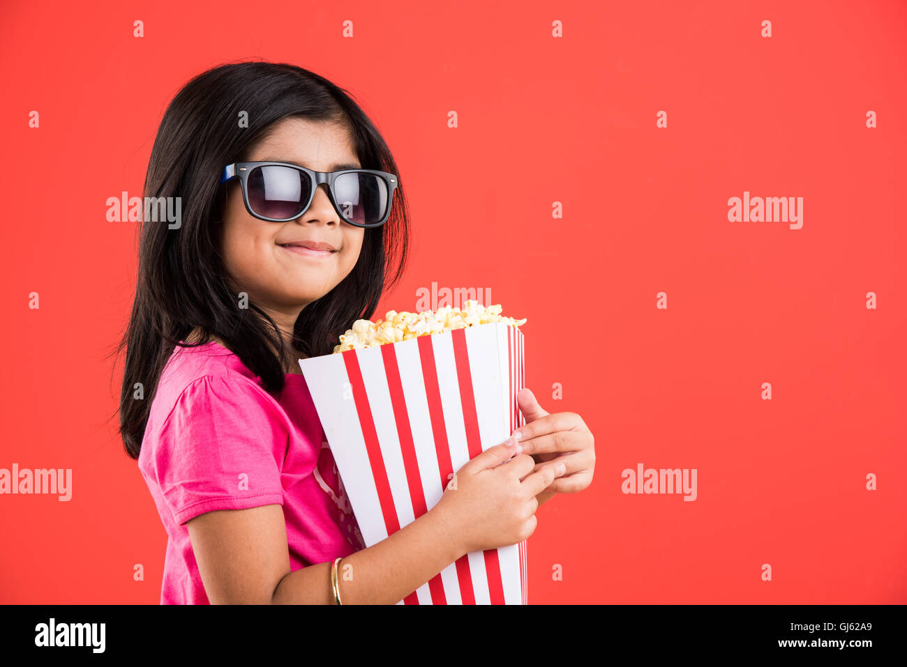 happy girl eating popcorn, indian girl eating popcorn, asian girl and ...