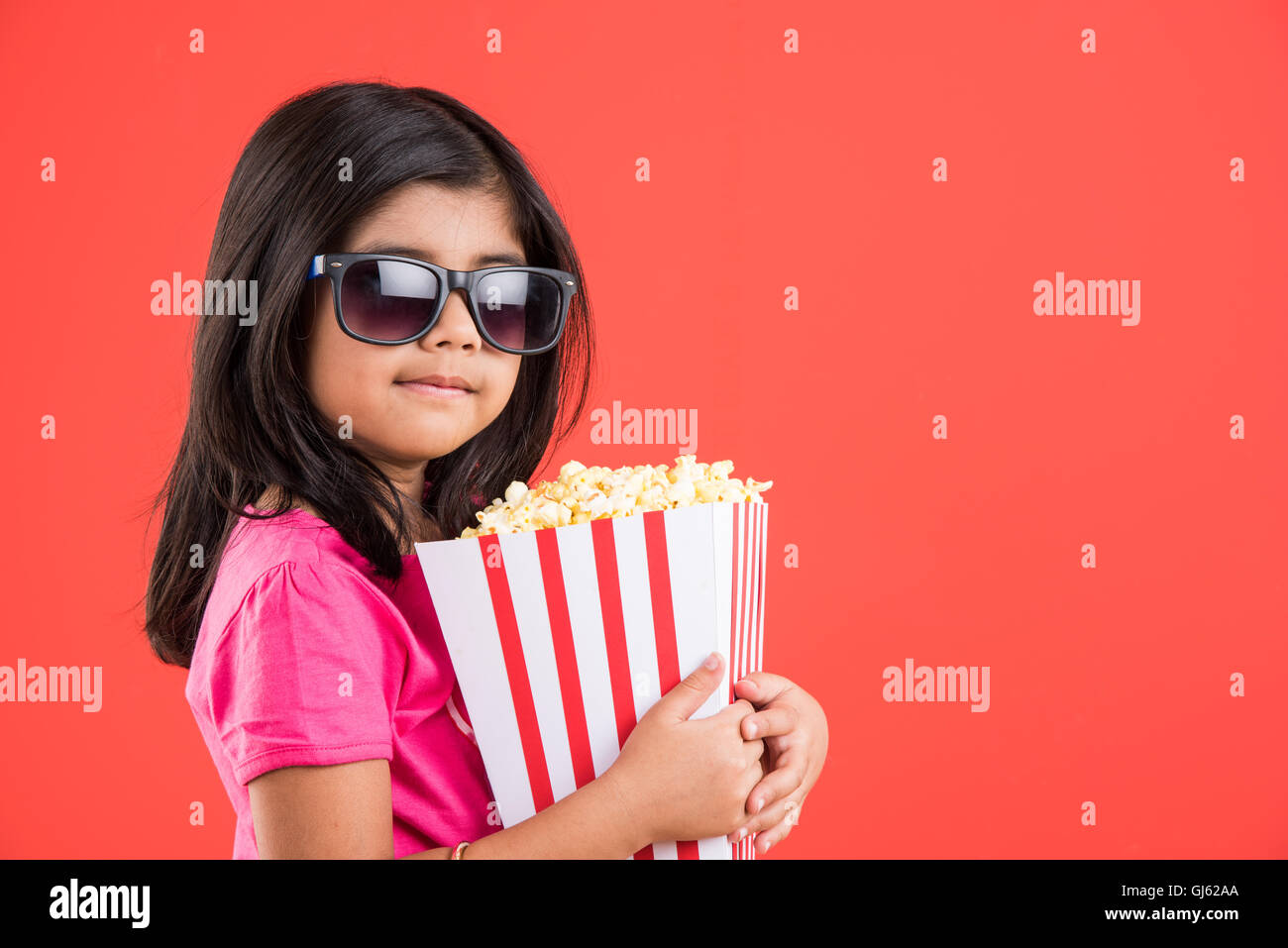 happy girl eating popcorn, indian girl eating popcorn, asian girl and ...